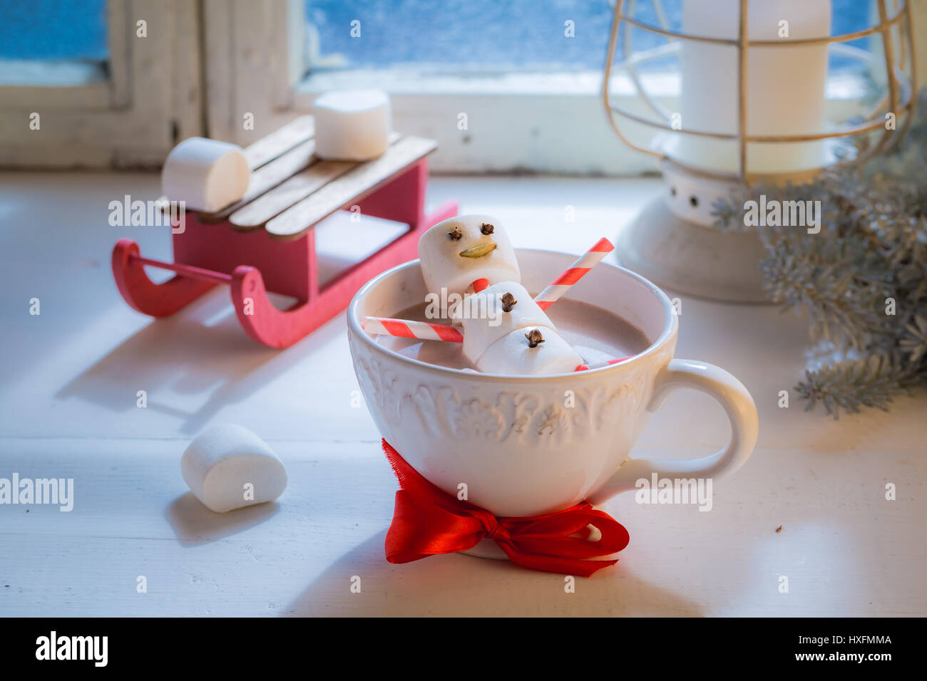 Relaxing in hot cocoa snowman for Christmas Stock Photo - Alamy