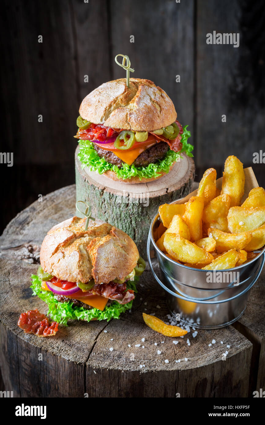 Chips and spicy burger with lettuce, beef and cheese Stock Photo - Alamy
