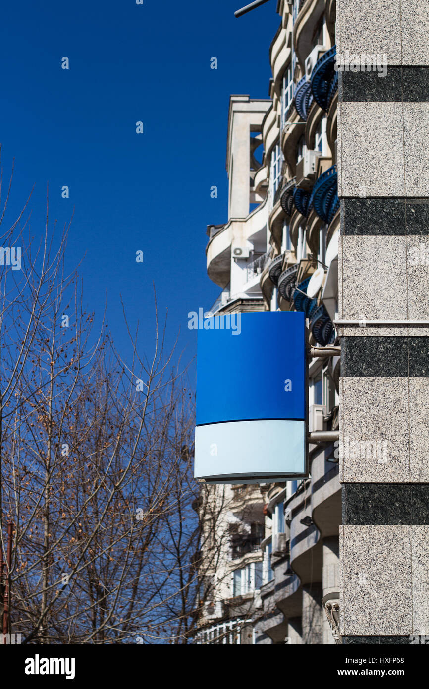 vertical side view of empty blue square signage on the exterior of a ...