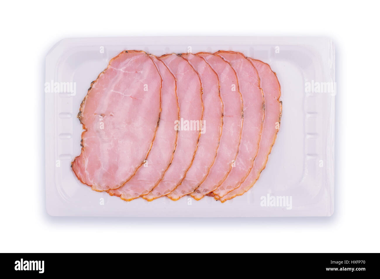 top view of slices of smoked pork loin ham in transparent plastic ...