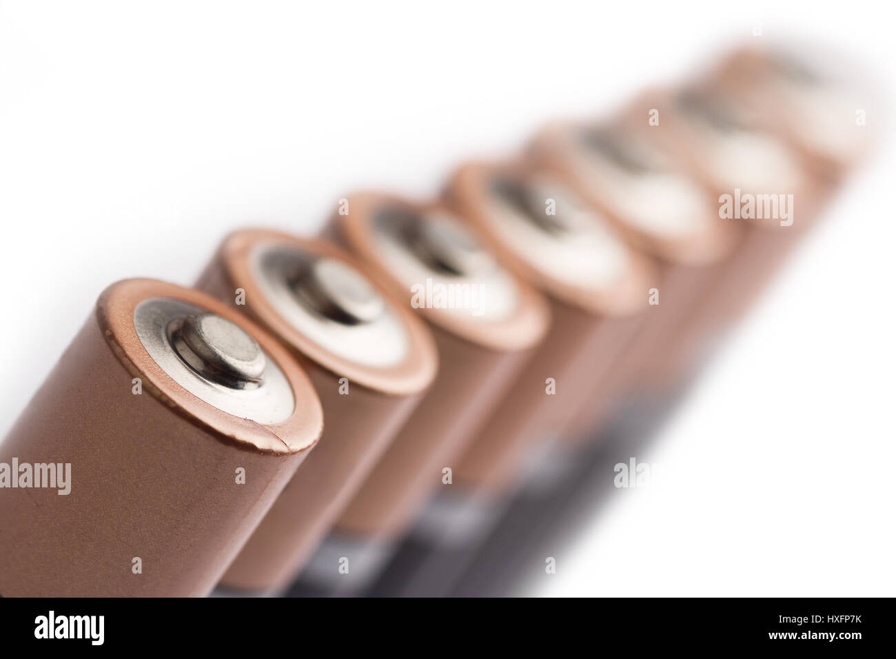 low angle closeup of row of electric batteries and accumulators AAA AA ...