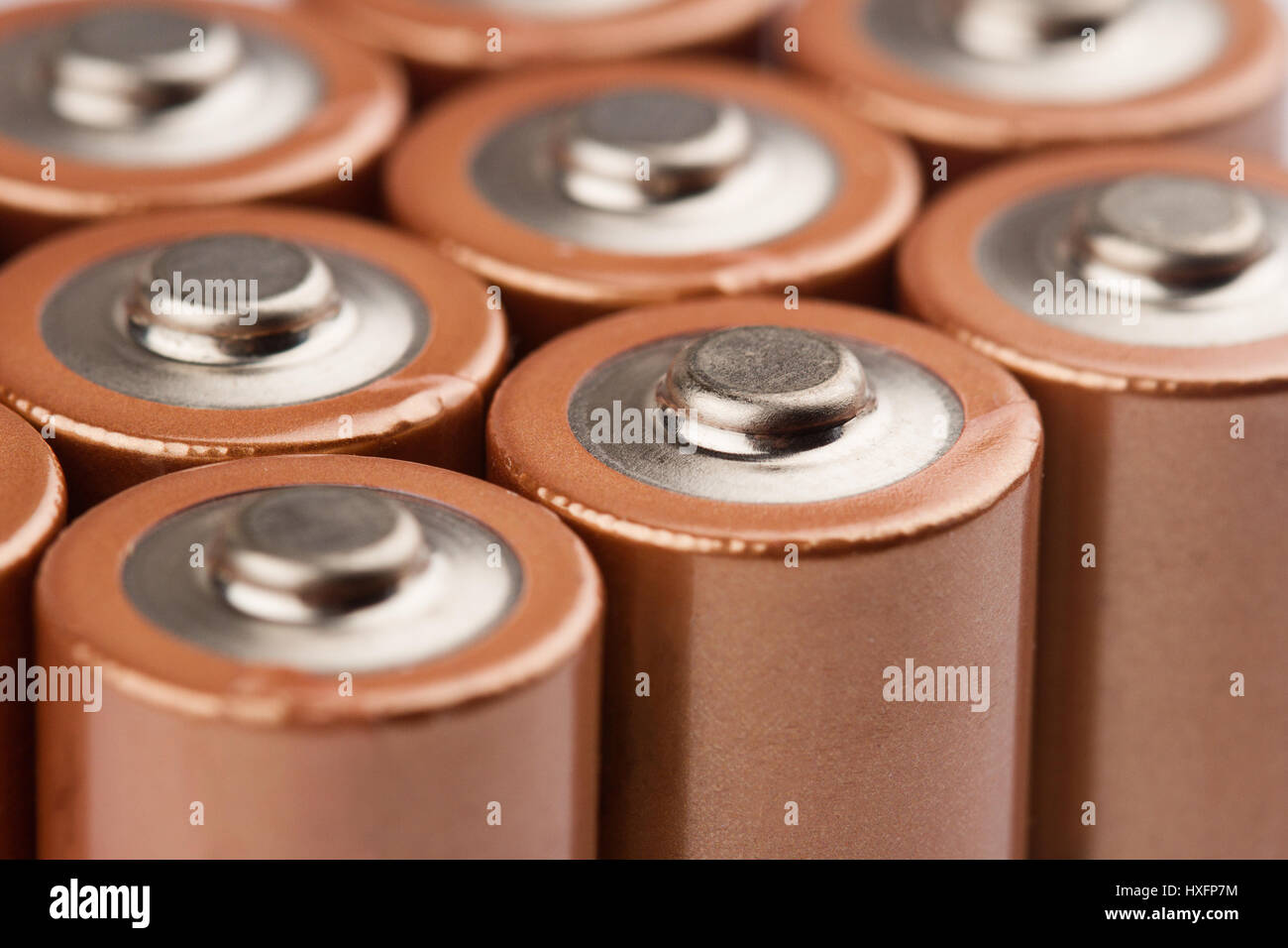 low angle closeup of electric batteries and accumulators AAA AA with ...