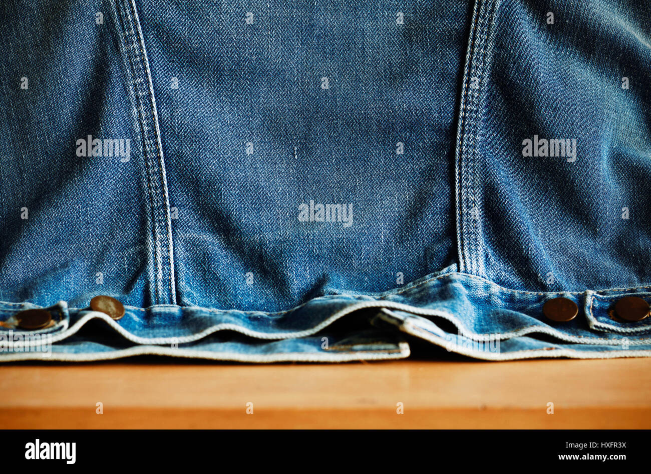 surface of denim jacket on the old wooden table Stock Photo - Alamy
