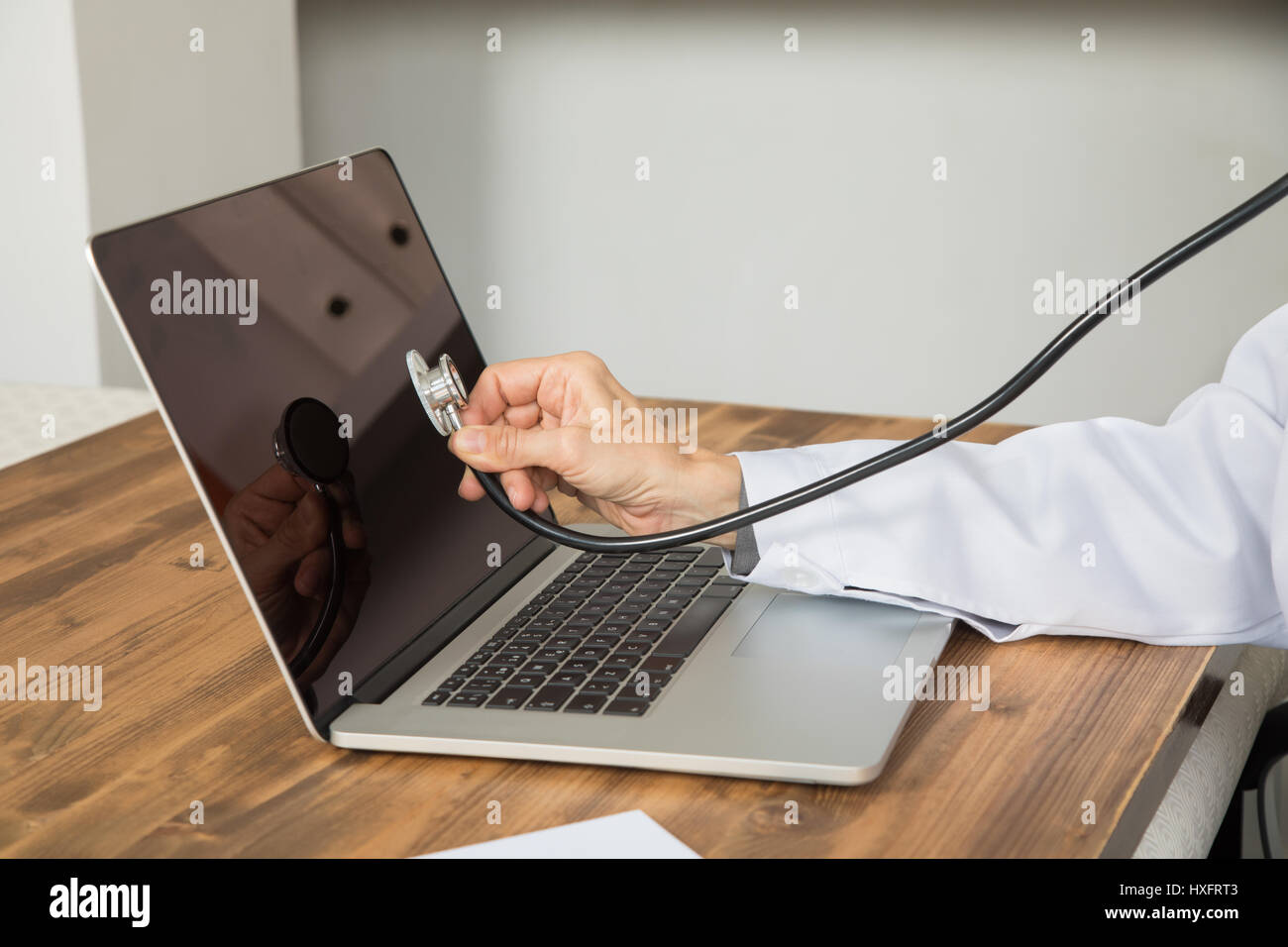hand of doctor woman, with white gown, showing stethoscope to screen of ...