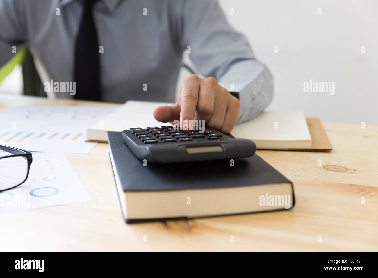 Businessman analyzing report on chart with calculator in office Stock ...