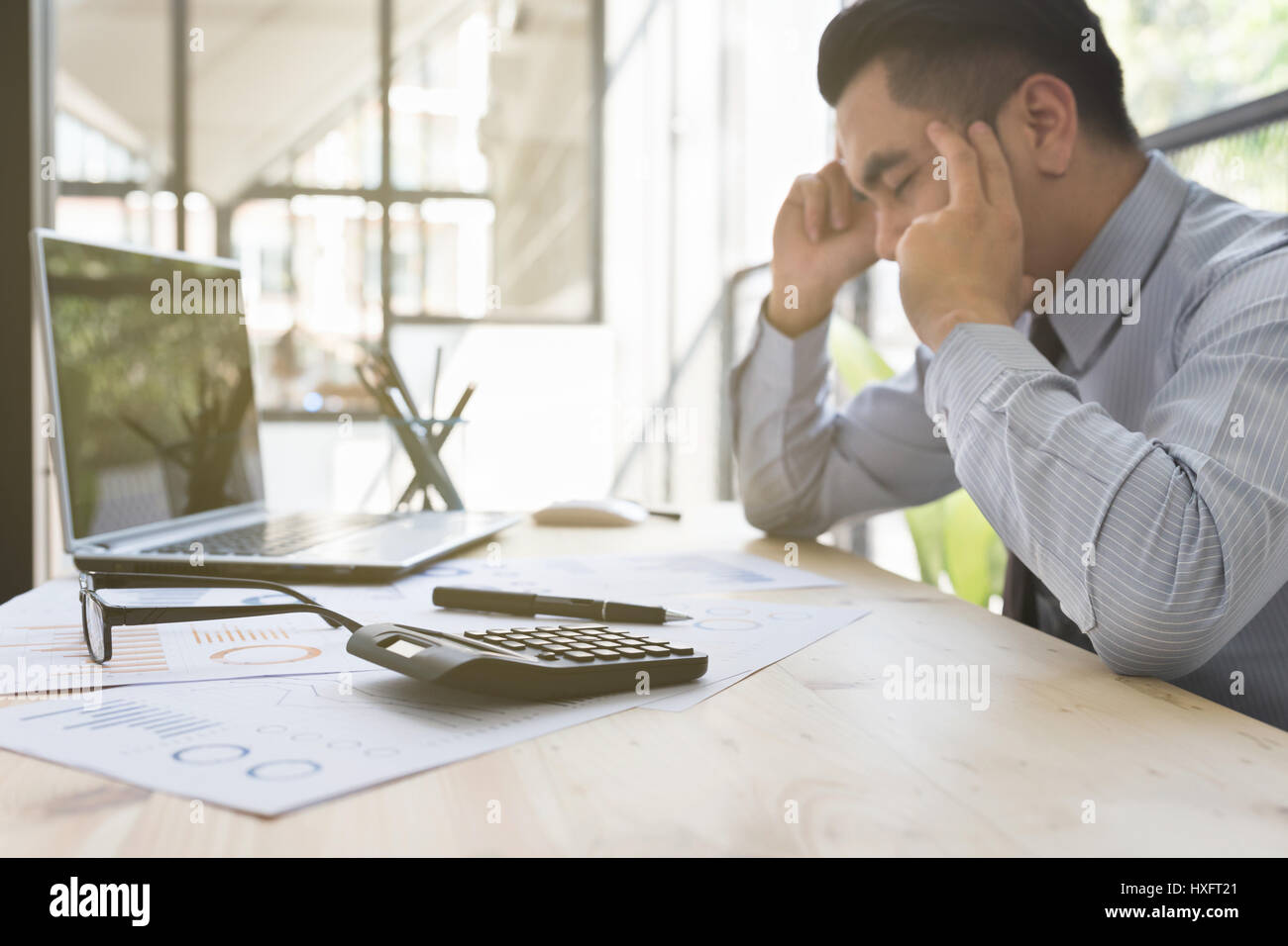 Young stressed and overworked businessman in modern office Stock Photo ...