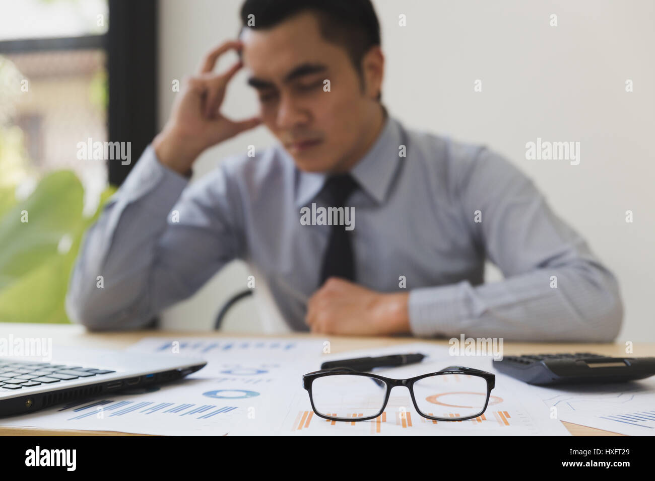 Young stressed and overworked businessman in modern office Stock Photo ...