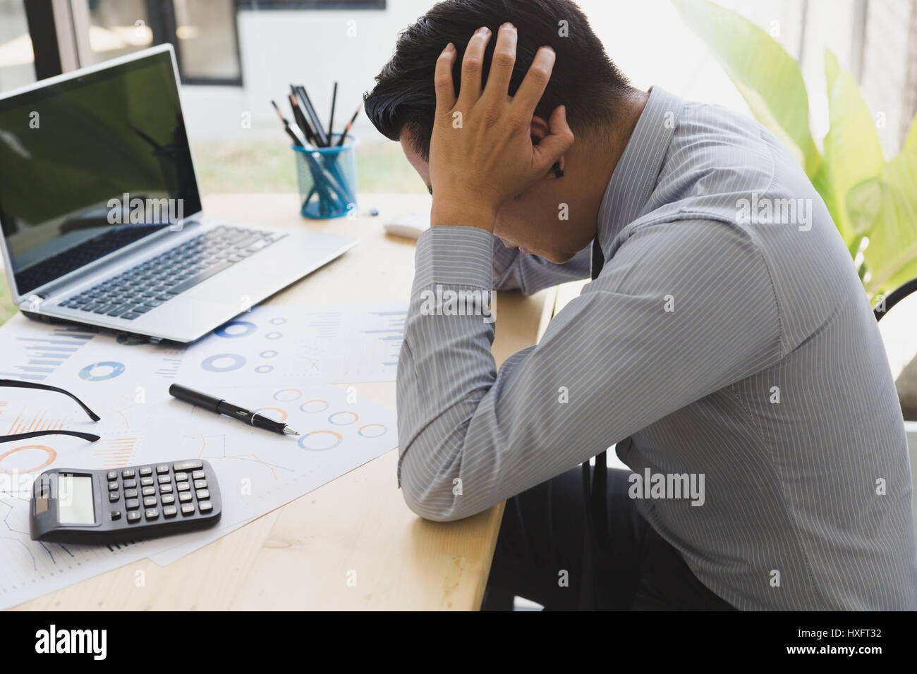 Young stressed and overworked businessman in modern office Stock Photo ...