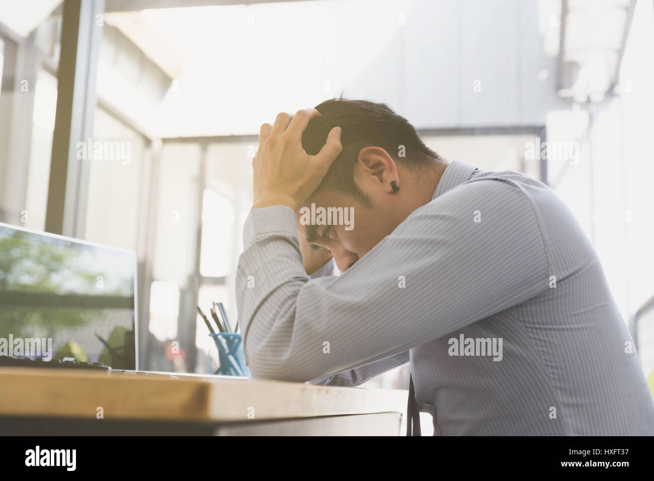 Young stressed and overworked businessman in modern office Stock Photo ...