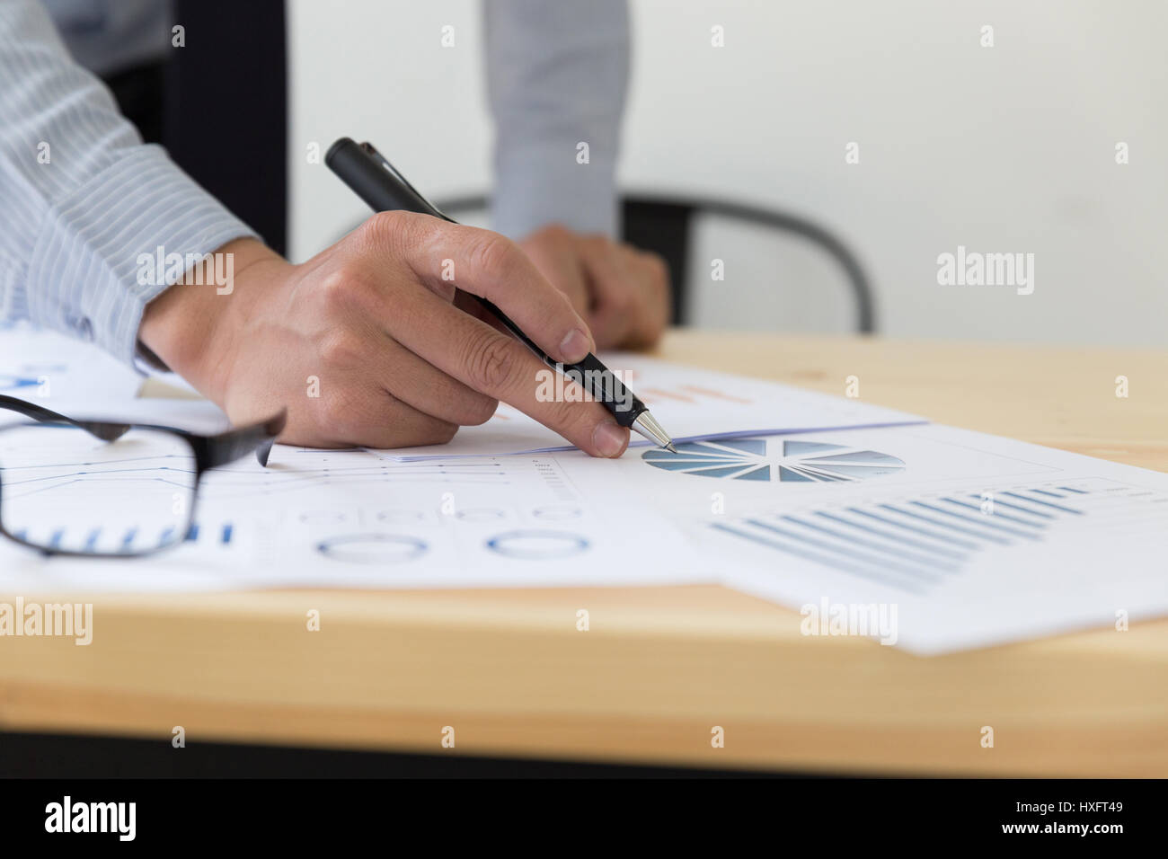 Businessman analyzing charts and graphs in office. business analysis ...