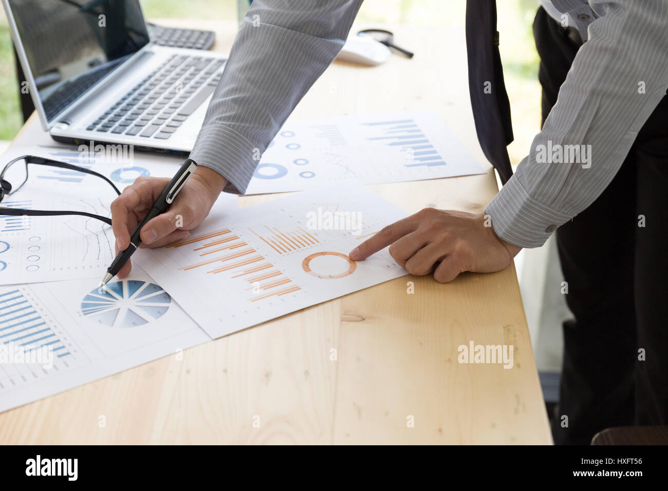 Businessman analyzing charts and graphs with modern laptop computer in ...