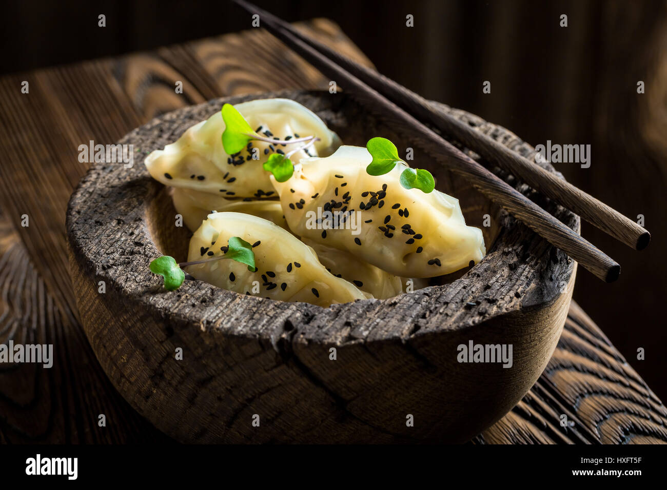 Enjoy your chinese dumplings in wooden bowl Stock Photo - Alamy