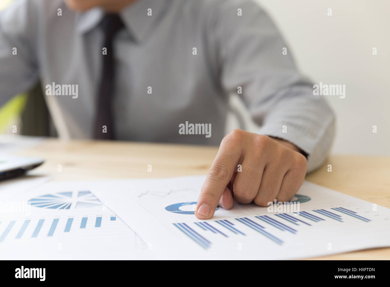 Businessman analyzing charts and graphs with modern laptop computer in ...