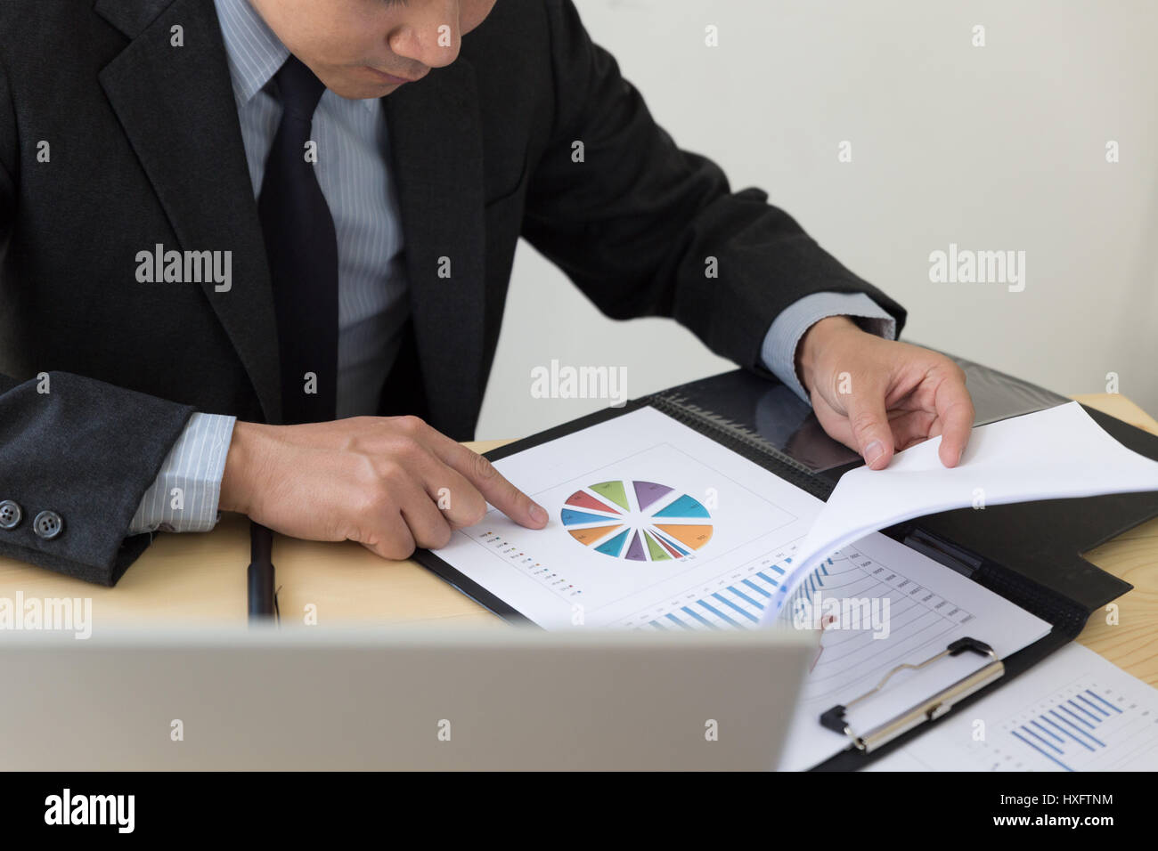 Businessman analyzing charts and graphs with modern laptop computer in ...