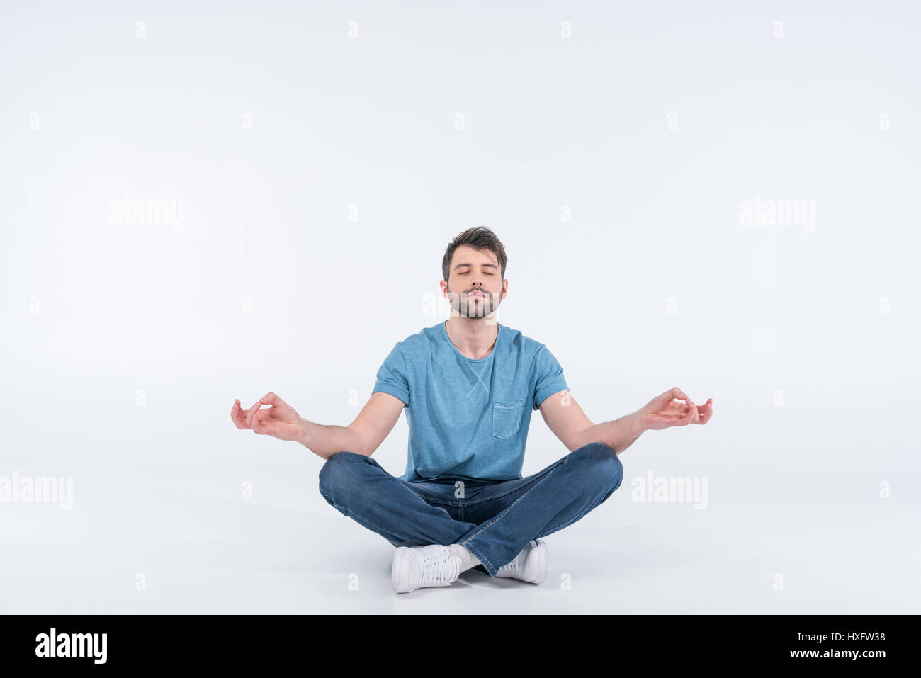 relaxing man sitting on floor on white Stock Photo - Alamy