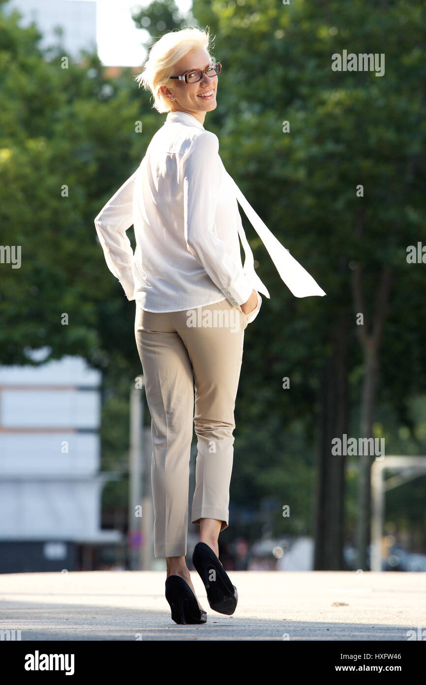Confident young woman walking hi-res stock photography and images - Alamy
