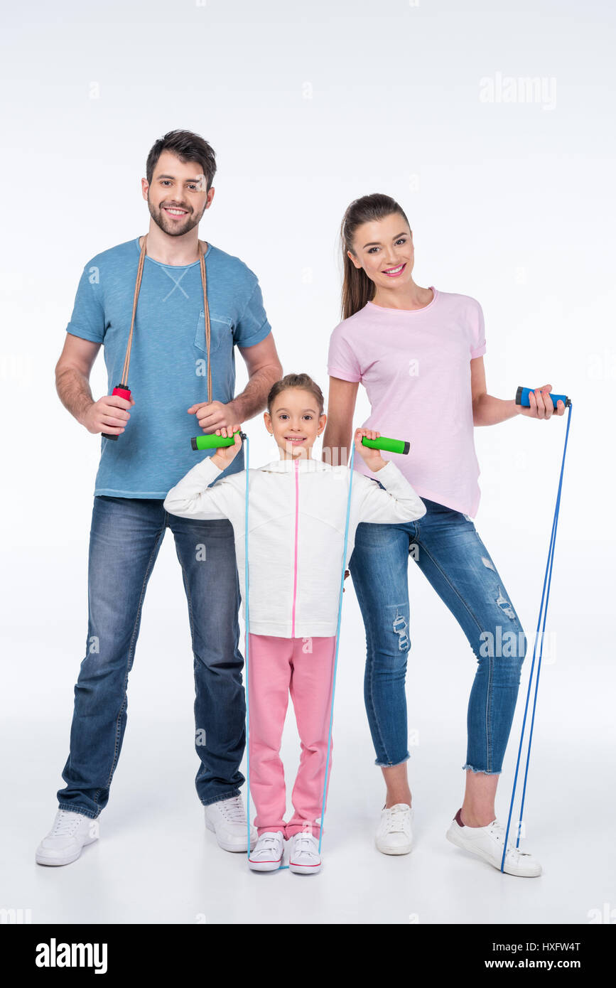 smiling young family with jump ropes on white Stock Photo - Alamy