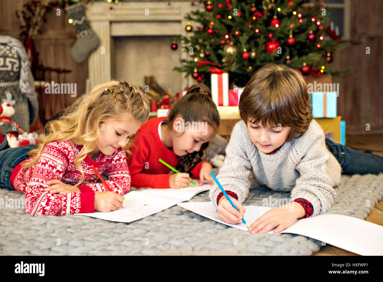 Happy kids having fun and drawing picture together Stock Photo - Alamy