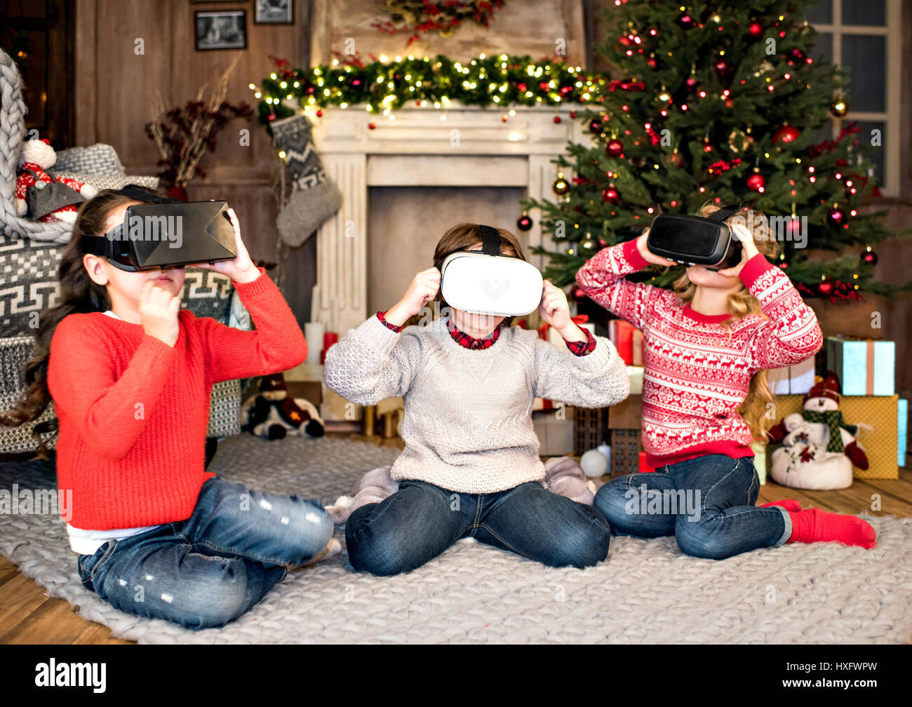 Children sitting on carpet and using virtual reality headsets Stock ...