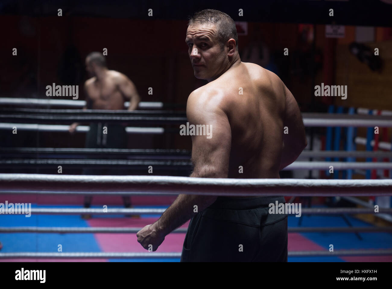 portrait from the back of muscular professional kickboxer who standing ...
