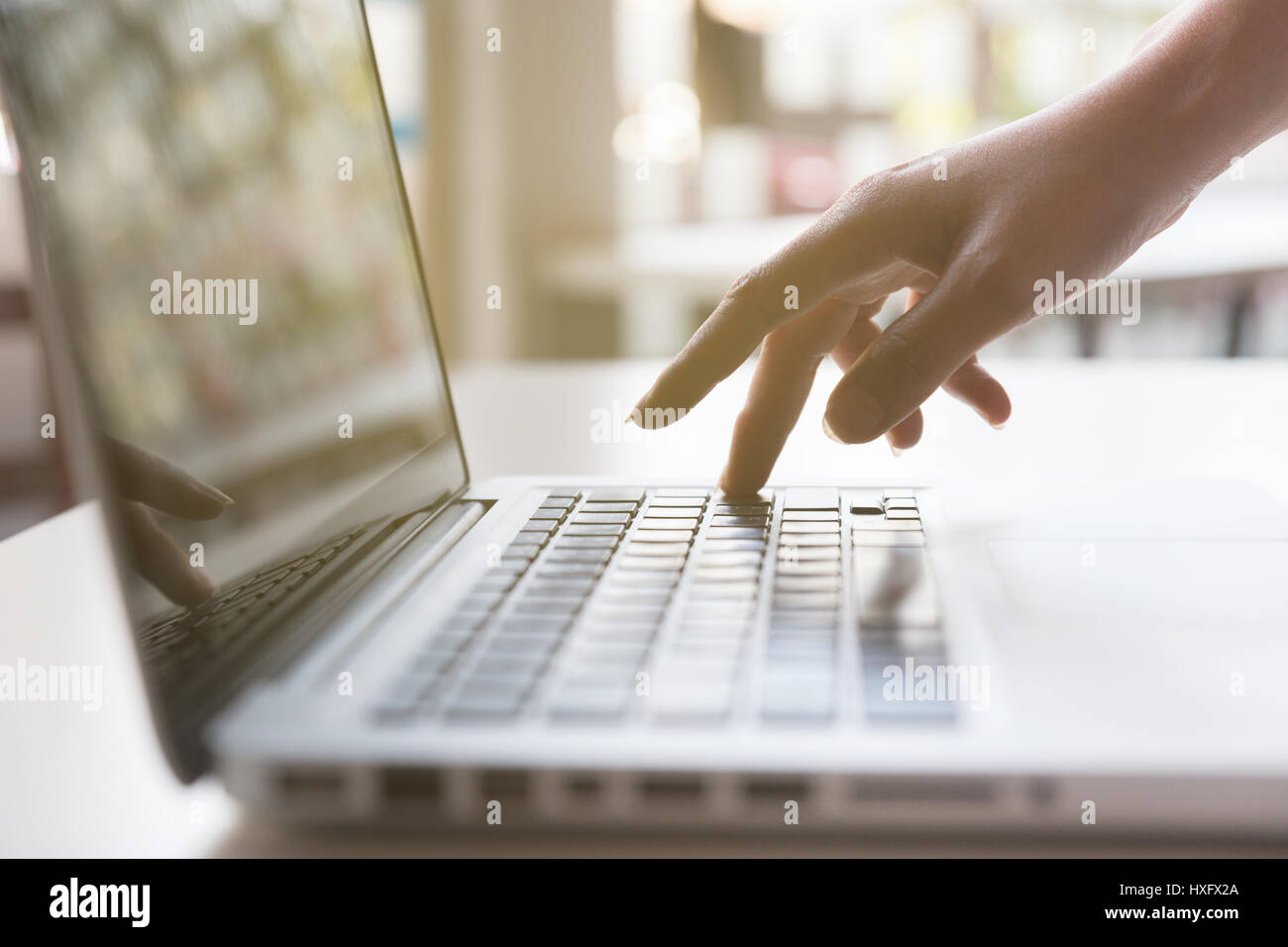 woman finger press button on laptop keyboard Stock Photo - Alamy