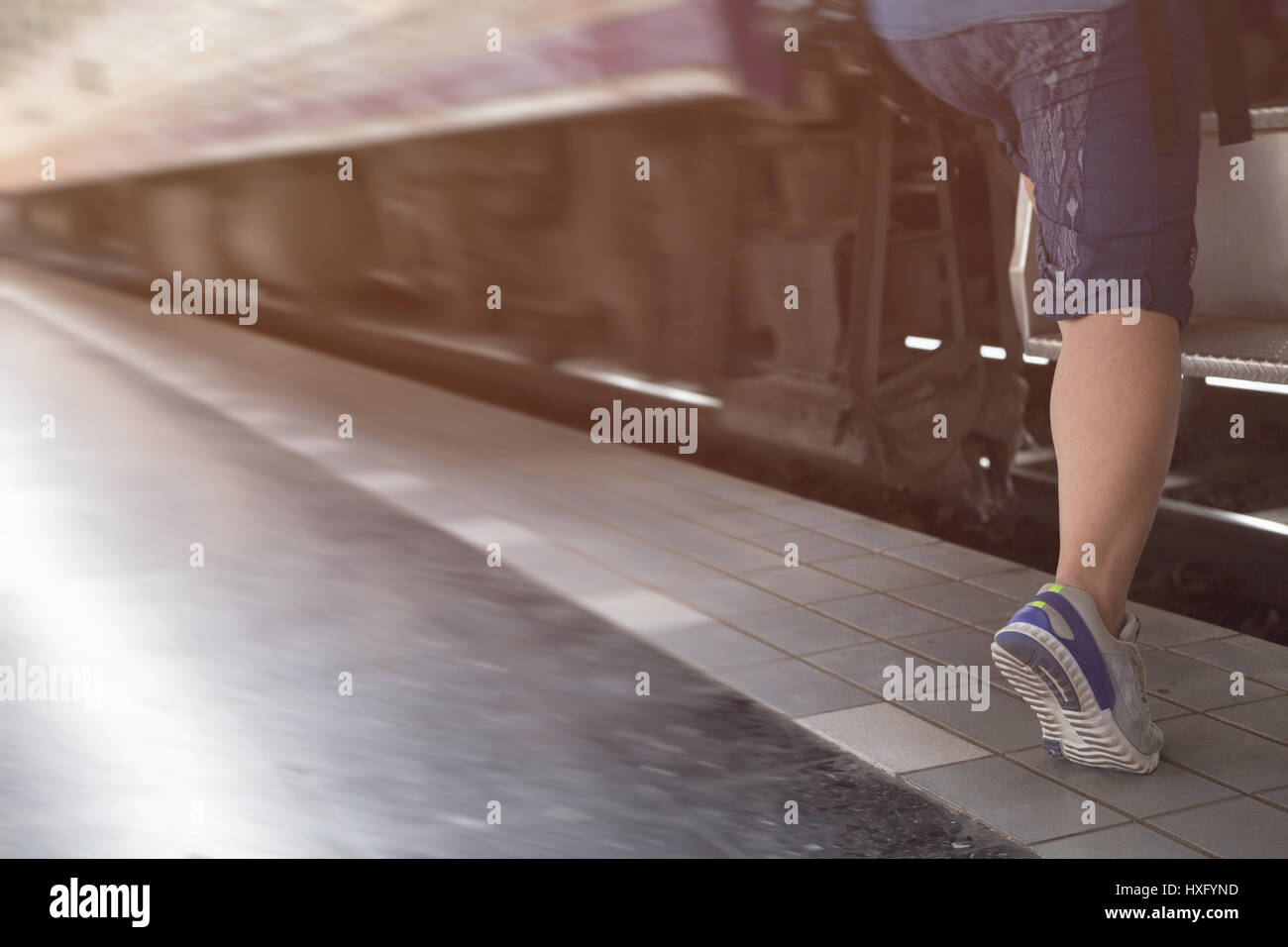 Traveler holding and stepping up to a train with backpack for journey ...