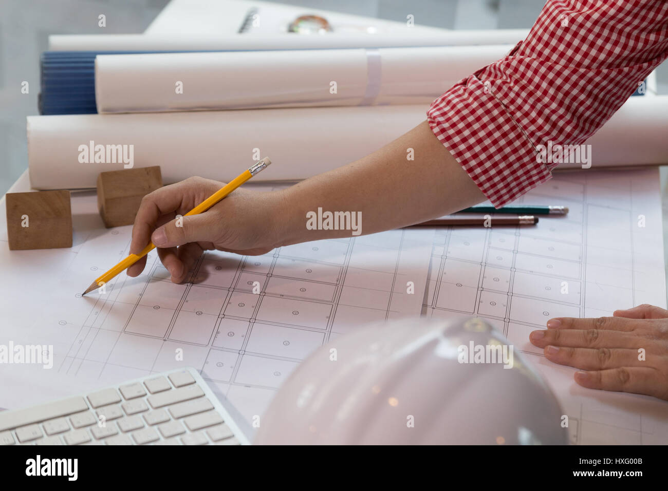 Architect or engineer working on blueprint at workplace - architectural ...