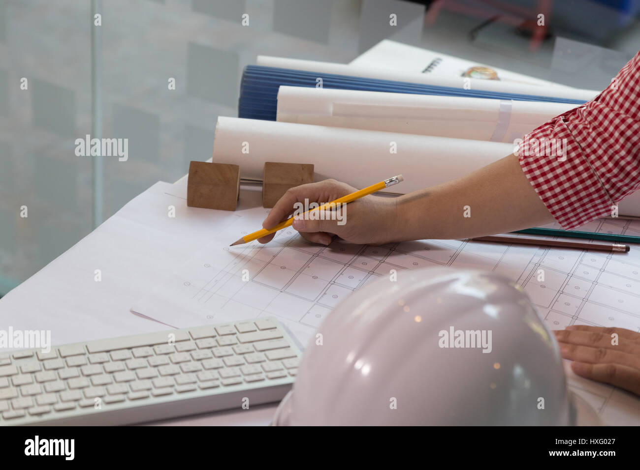 Architect or engineer working on blueprint at workplace - architectural ...