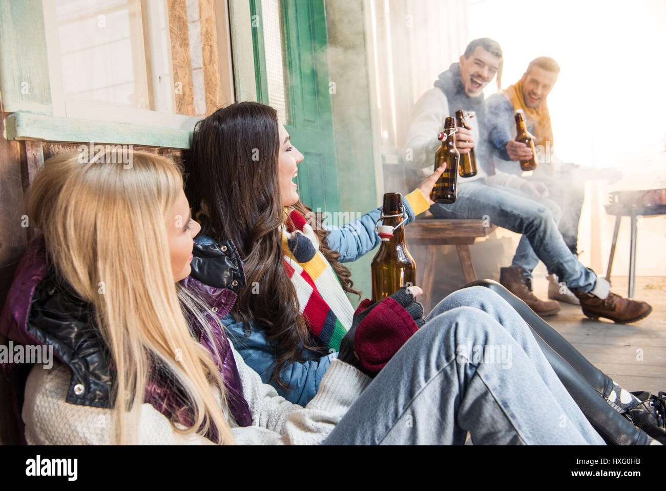 Friends drinking beer on porch hi-res stock photography and images - Alamy
