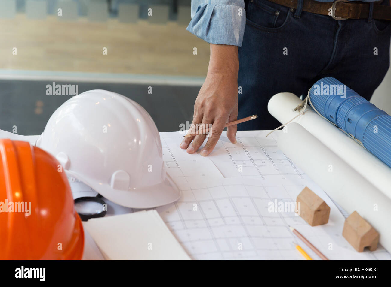 Architect or engineer working on blueprint at workplace - architectural ...