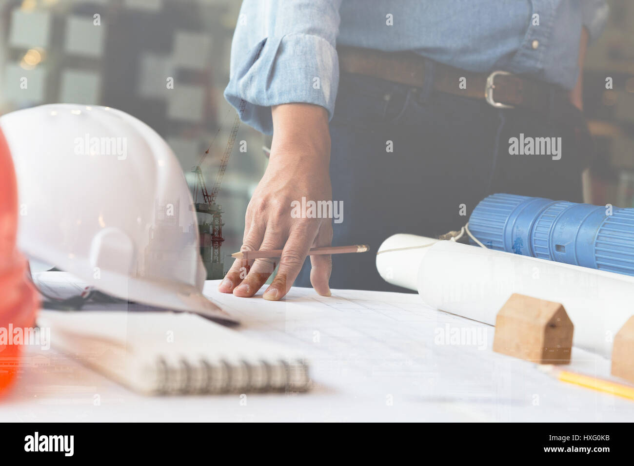 Architect or engineer working on blueprint at workplace - architectural ...