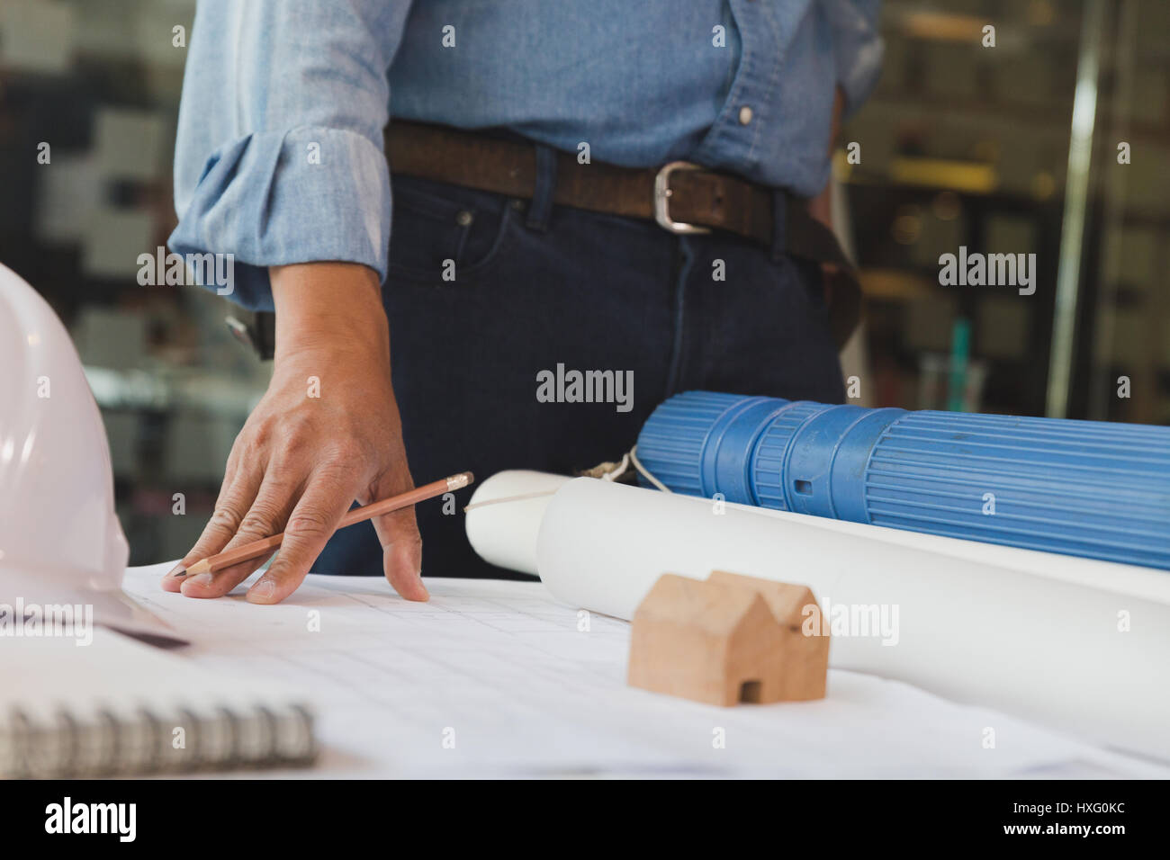 Architect or engineer working on blueprint at workplace - architectural ...