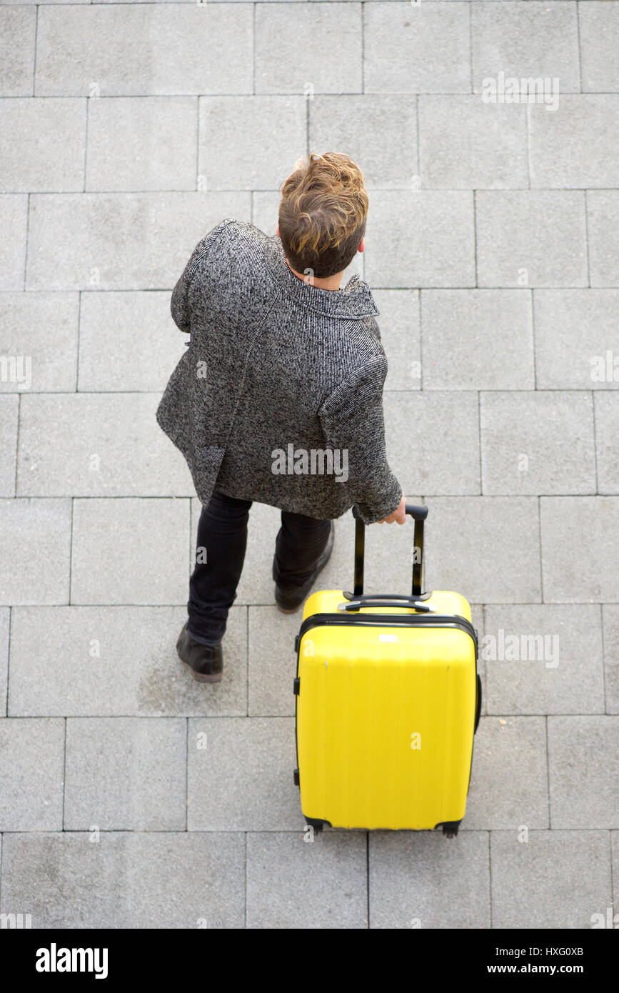 Top view traveling man walking with suitcase Stock Photo - Alamy