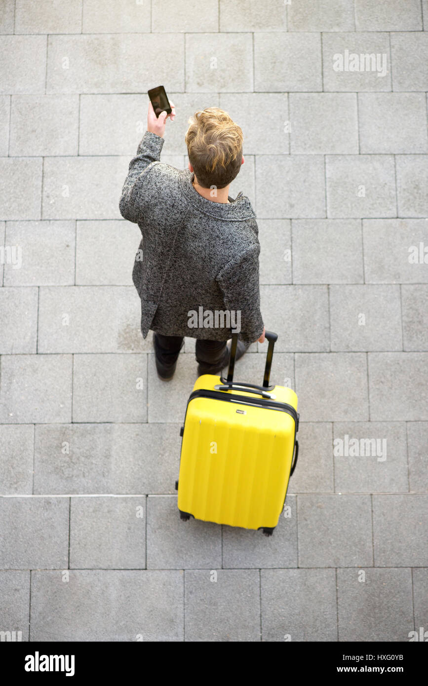 Top view traveling man walking with mobile phone ad suitcase Stock ...