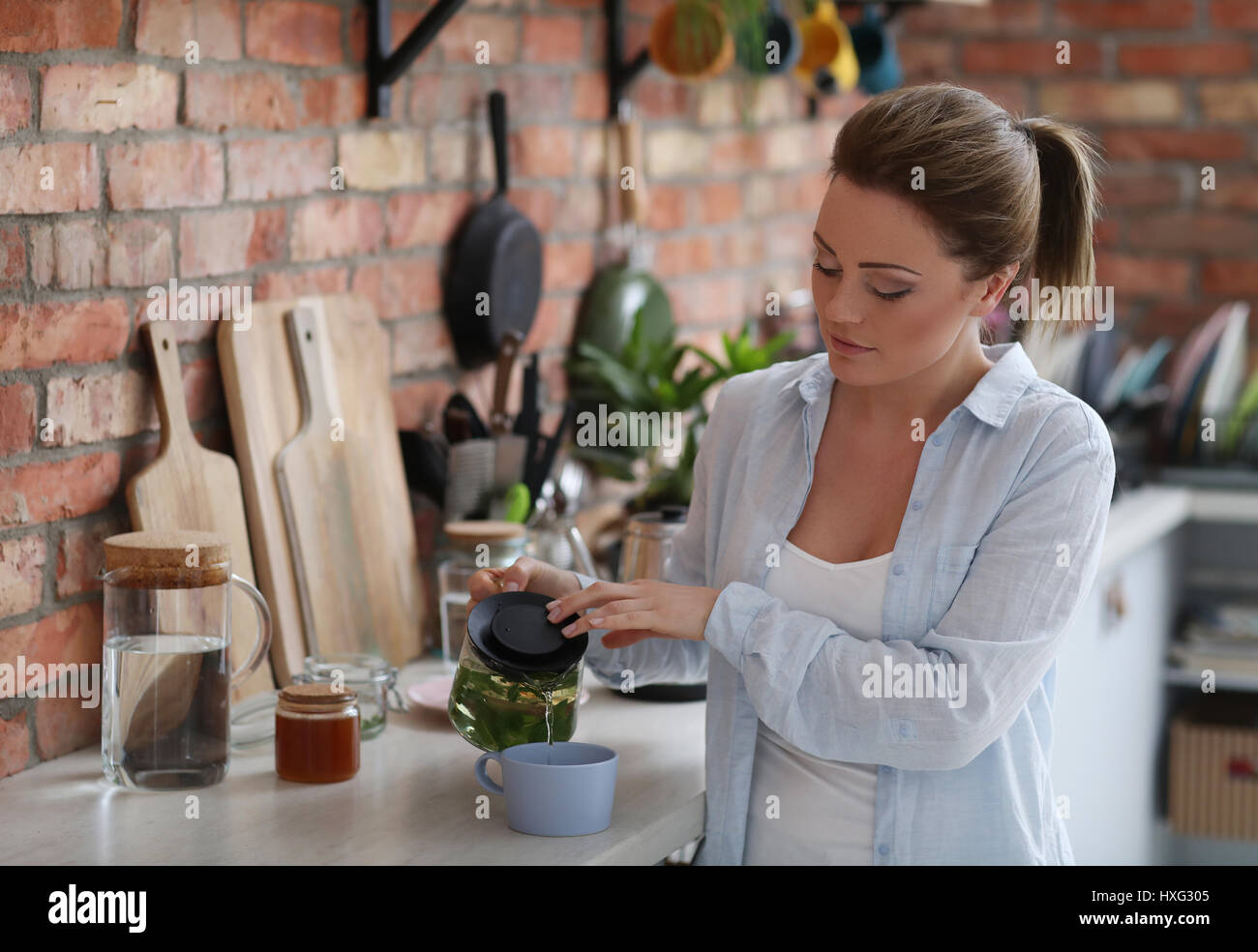 Woman in kitchen Stock Photo - Alamy