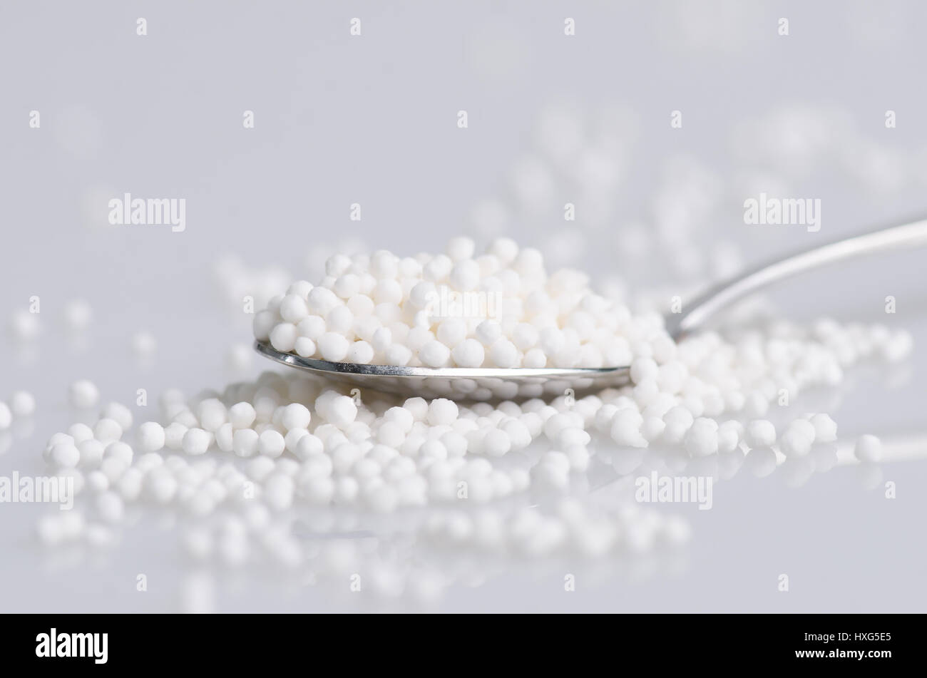 Granulated cassava (tapioca) in steel spoon isolated on white Stock ...