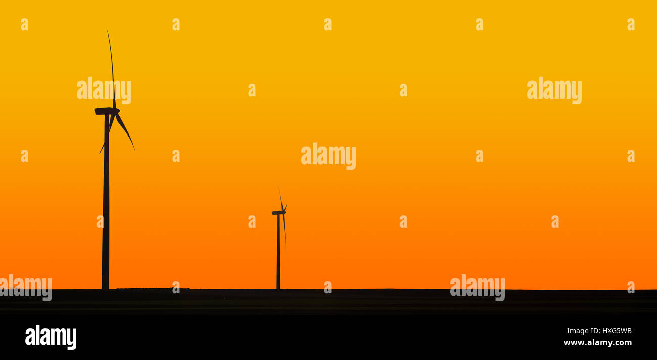 Wind turbines in orange sunset Stock Photo - Alamy