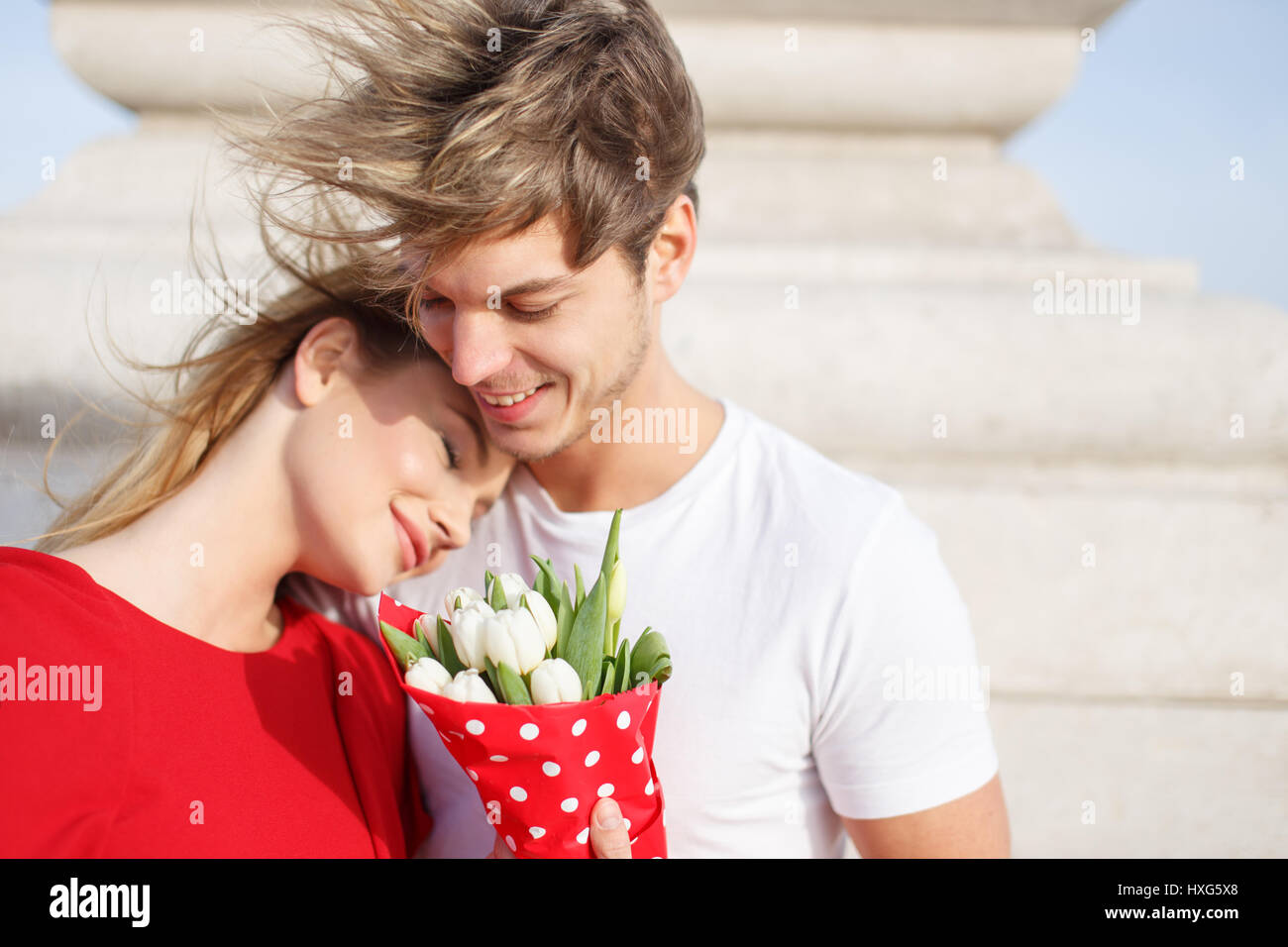 Happy young couple cuddle outdoor Stock Photo - Alamy