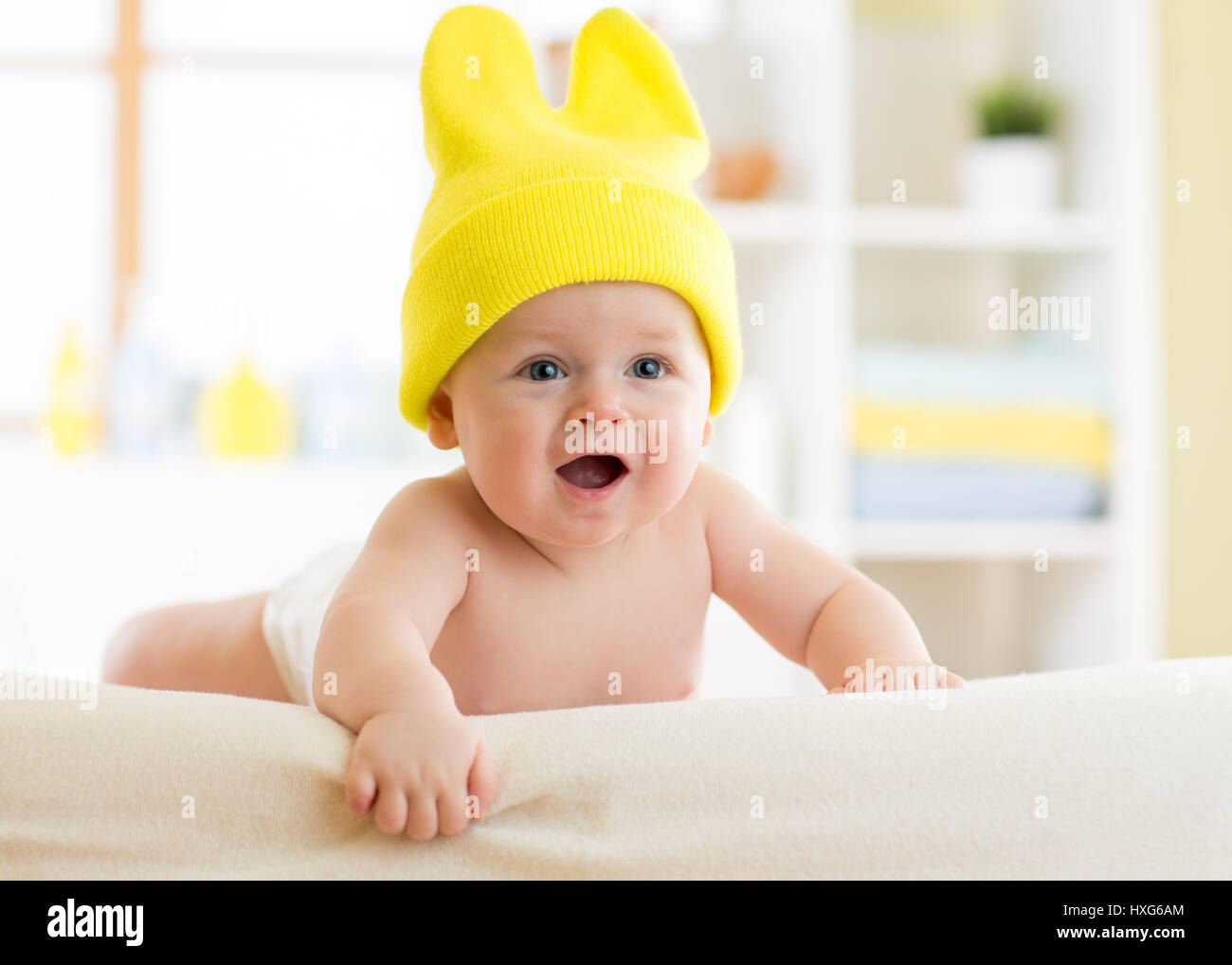 Baby boy weared in funny hat in nursery Stock Photo - Alamy