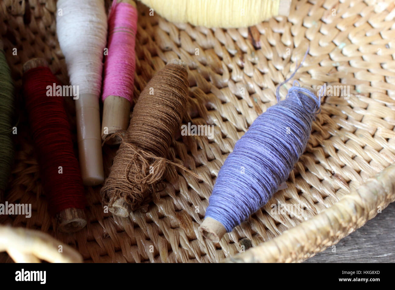 colorful bobbins of thread in basket Stock Photo - Alamy