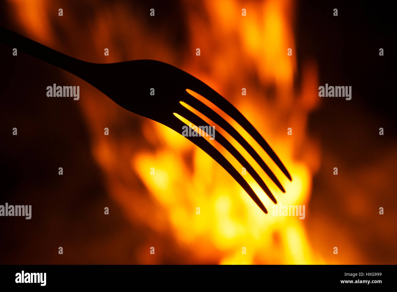fork on a background of fire rotate right,silhouettes, hell kitchen, a ...