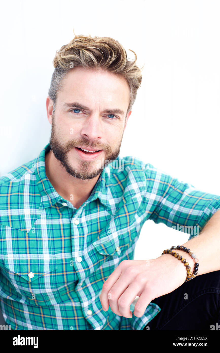 Close up portrait of a handsome modern man with beard and green shirt ...