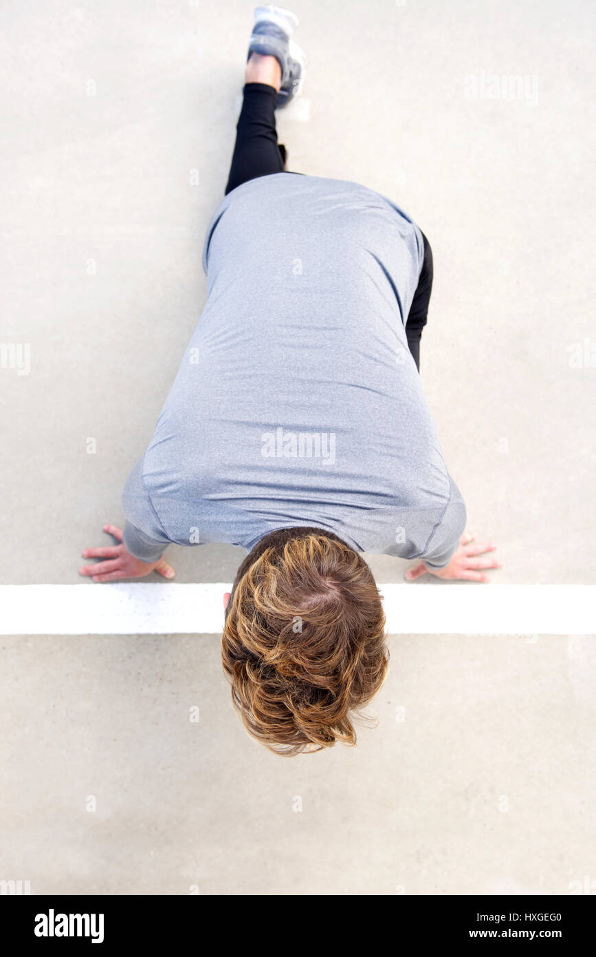 Portrait from above man in starting position for race Stock Photo - Alamy