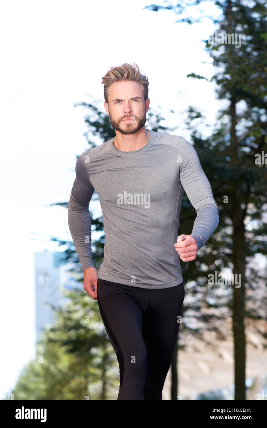 Portrait of an active man running outside Stock Photo - Alamy