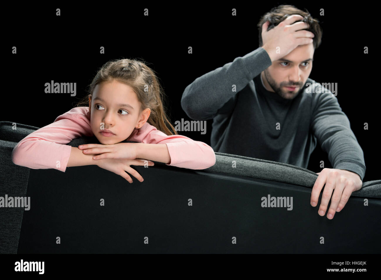 Upset father and daughter sitting on couch and looking away, family ...