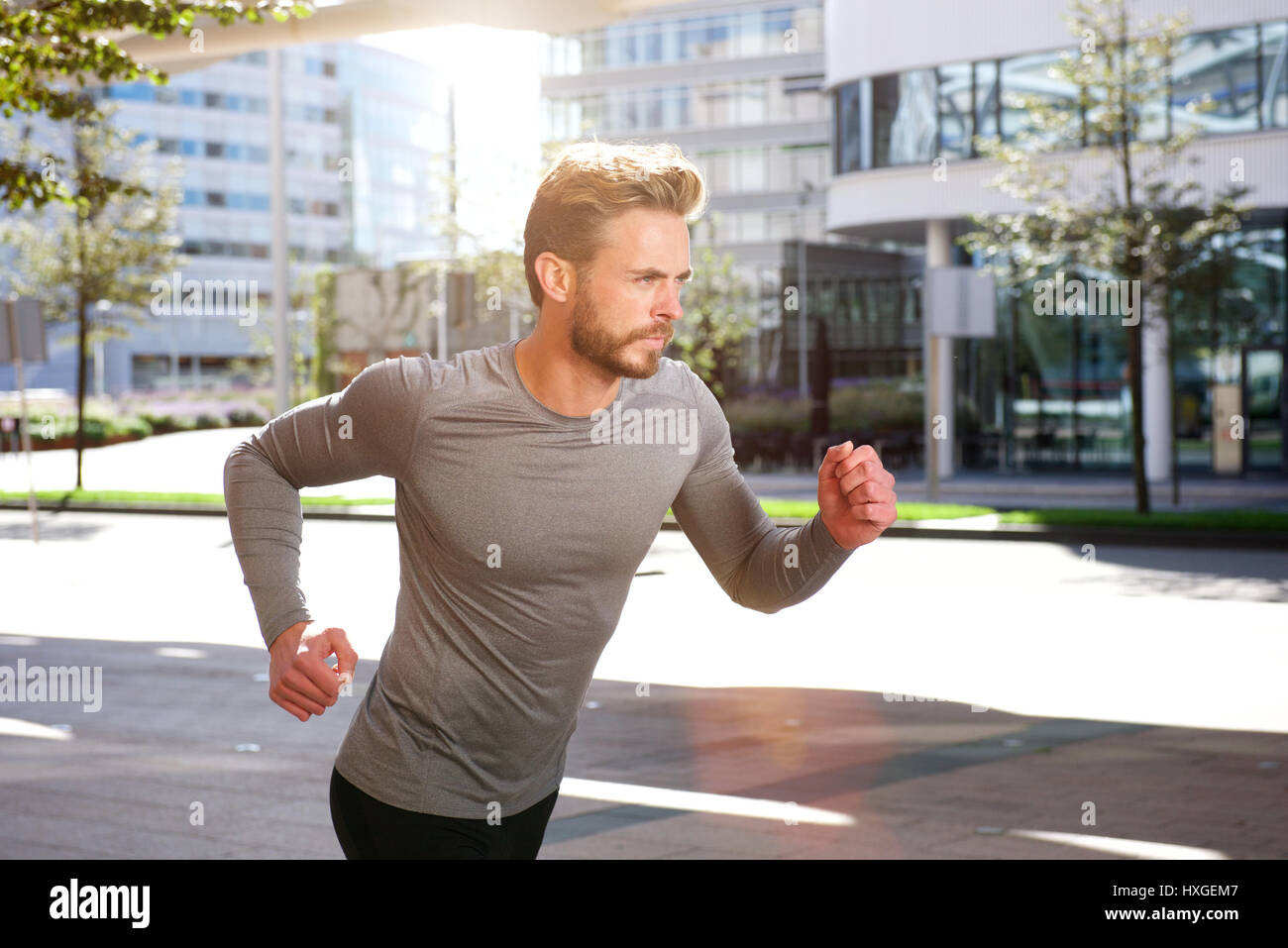 Portrait of an active sports man running outside in the city Stock ...