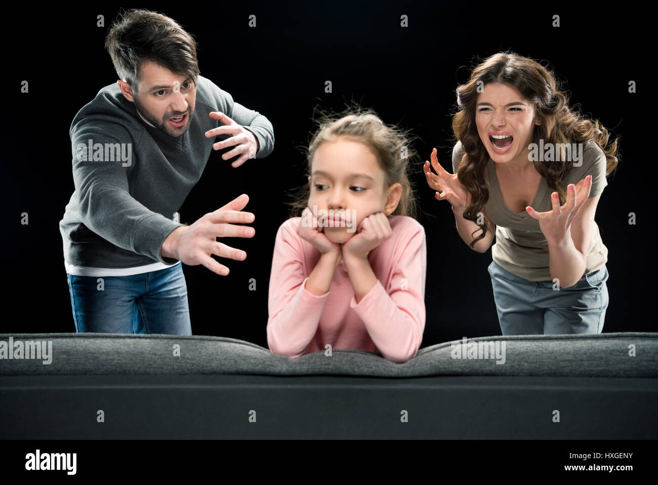 Aggressive parents screaming at little daughter on black, family ...