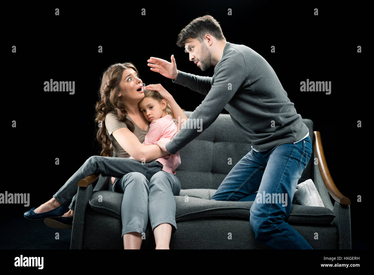 scared mother covering daughter from aggressive father, family violence ...