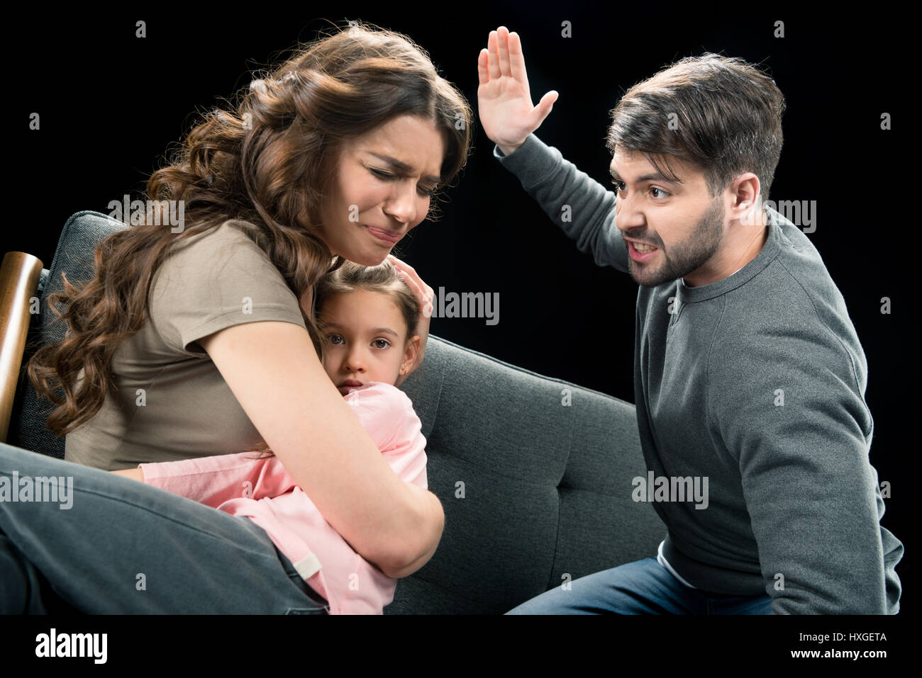 scared mother covering daughter from aggressive father, family violence ...