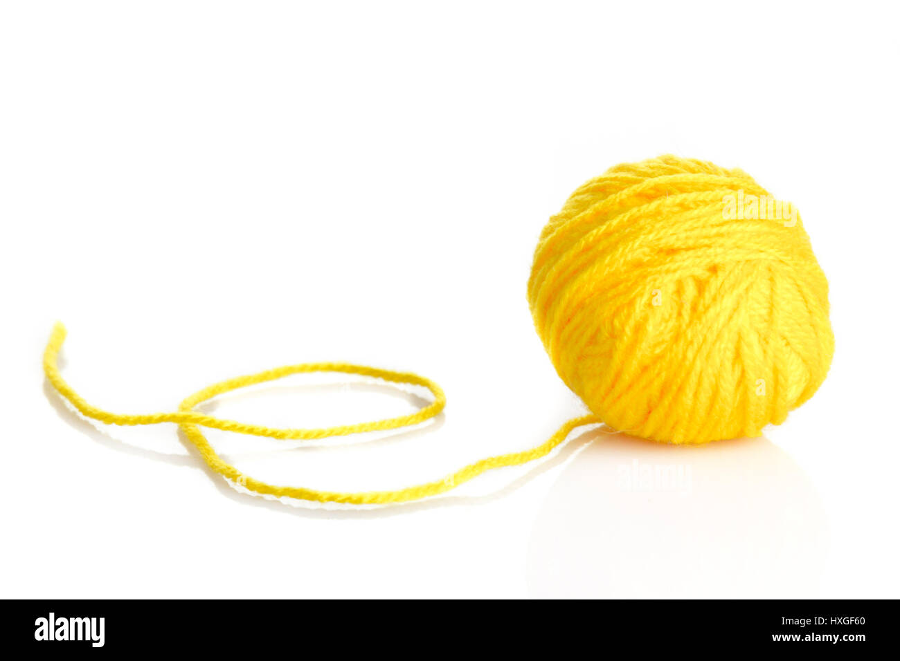 Yellow wool yarn ball isolated on white background Stock Photo - Alamy